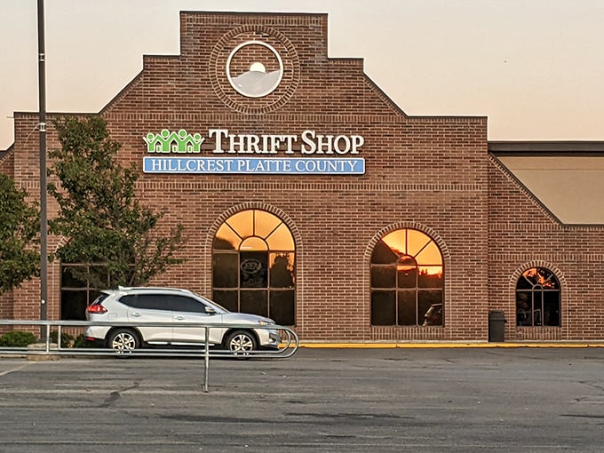 The stately brick façade of Hillcrest Thrift Shop stands proudly against a blue Missouri sky, promising treasure hunters adventures that await inside.
