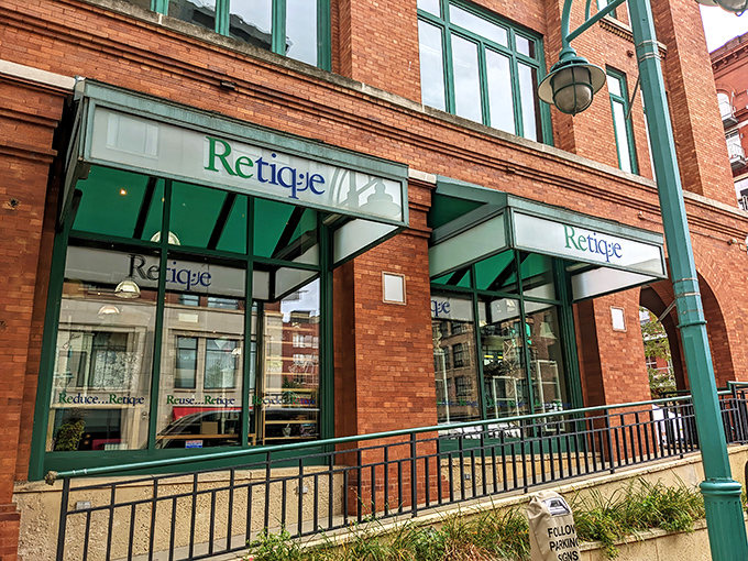 The distinctive brick facade of Retique welcomes bargain hunters with its elegant green signage – Milwaukee's worst-kept secret for fashionistas on a budget.