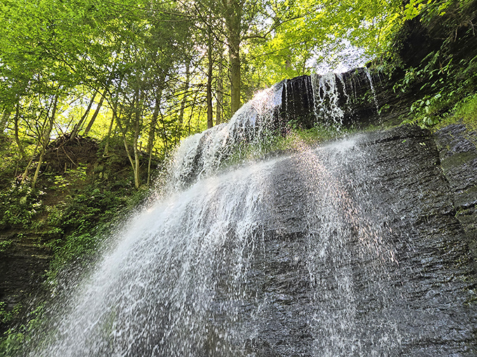 Nature's own masterpiece in motion. Buttermilk Falls cascades down 45 feet of ancient rock face, creating that signature white froth that inspired its name.