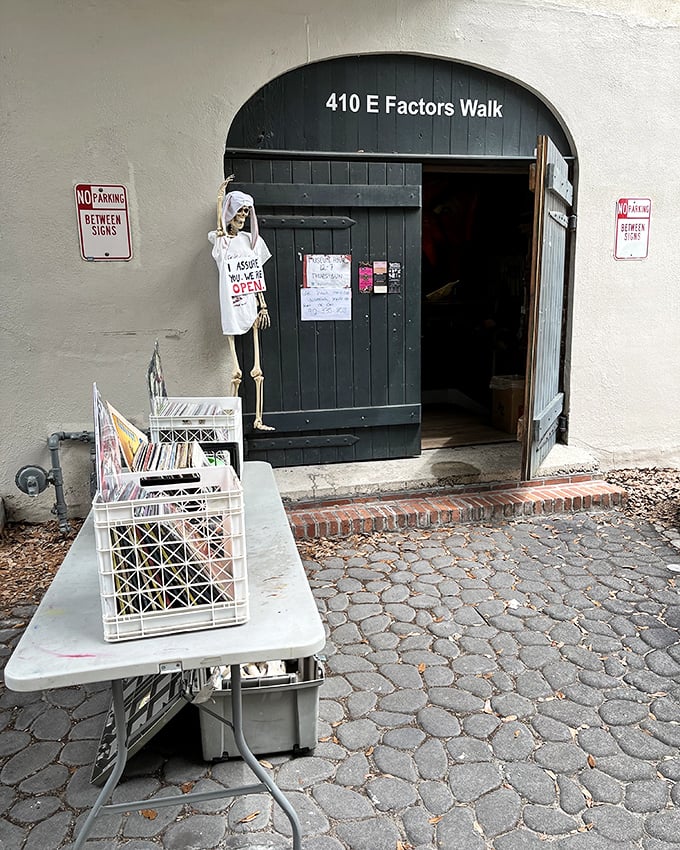 The unassuming entrance to Savannah's strangest attraction. That handwritten "I assure you, we're OPEN" sign is both an invitation and a dare.