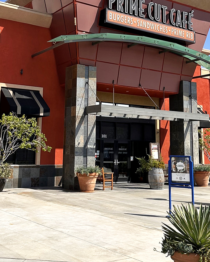 The terra cotta façade glows like a beacon for hungry souls, promising meaty salvation within those stylish doors. 