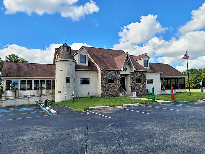The lighthouse-inspired exterior of Kathy's Crab House stands as a beacon to seafood lovers, promising maritime treasures within those stone-faced walls.