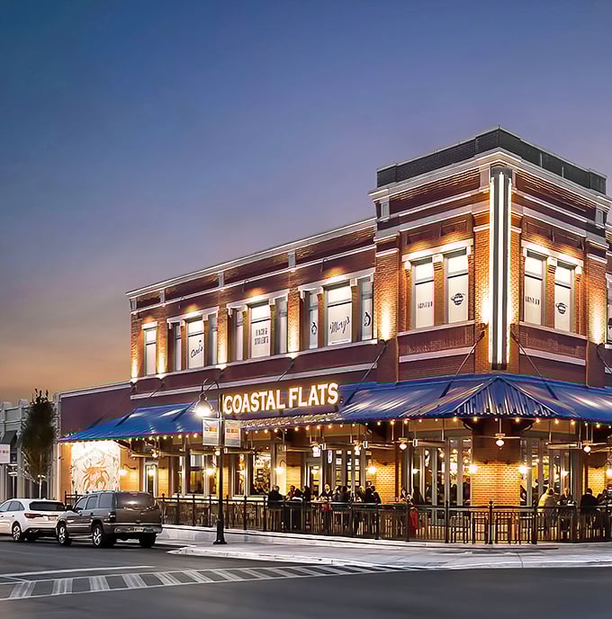Coastal Flats glows like a beacon at twilight, its brick façade and blue awnings promising seafood salvation in suburban Maryland.