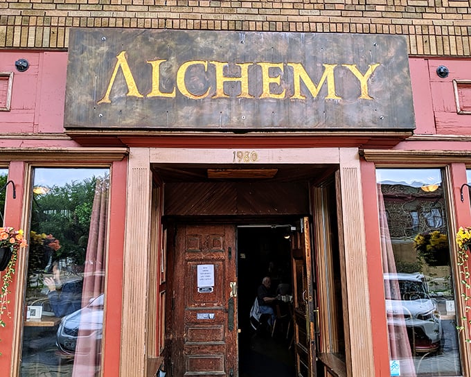 The pink facade and weathered "ALCHEMY" sign aren't trying to impress anyone—they're too busy promising authentic flavors that will do all the talking necessary.