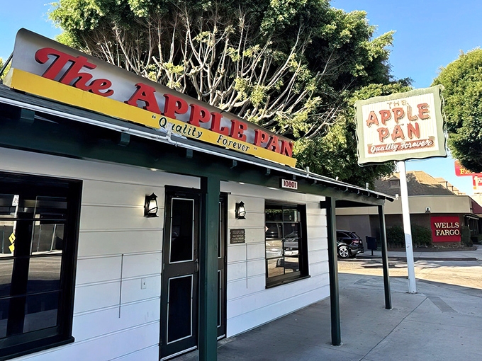 The unassuming exterior of The Apple Pan stands like a time capsule on West Pico Boulevard, its vintage sign promising "Quality Forever" since 1947.