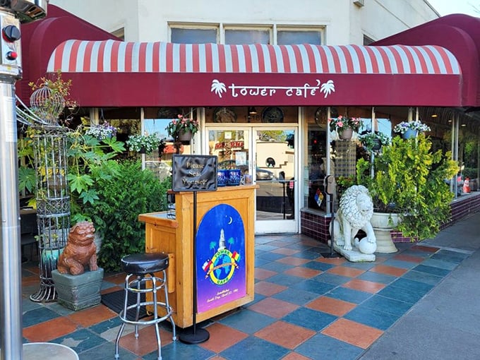 Welcome to flavor paradise! Tower Café's vibrant exterior with its distinctive red awning and lush greenery promises an escape from ordinary breakfast experiences.