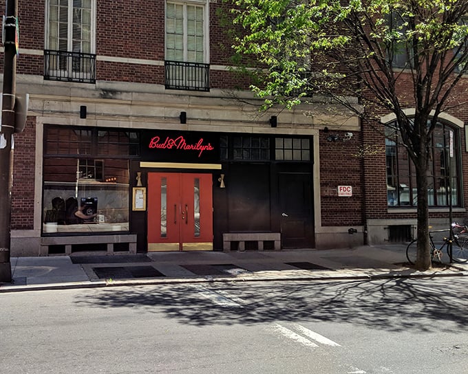 Those bright orange doors aren't just an entrance—they're a promise of the comfort food paradise waiting inside. Philadelphia's culinary scene at its most inviting.