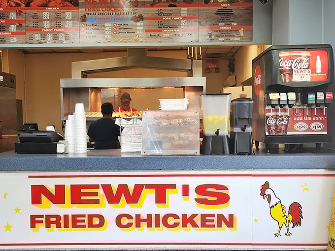 The bright red Newt's Fried Chicken sign promises salvation for the hungry soul. Simple counter service, maximum flavor delivery.
