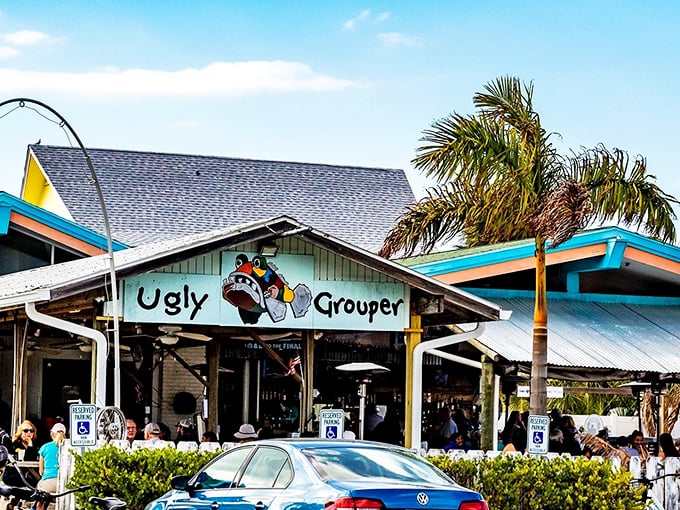 The turquoise-trimmed facade of The Ugly Grouper welcomes visitors with its cartoon mascot grinning from the sign—Florida casual at its finest.