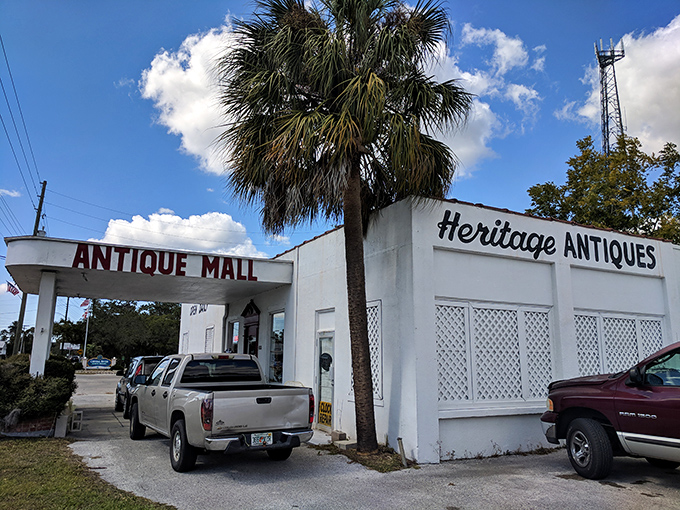 The unassuming white exterior of Heritage Antiques Mall in Crystal River hides a universe of treasures within, like a time-travel portal disguised as a building.