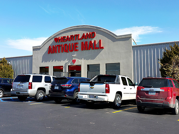 The iconic red lettering of Heartland Antique Mall beckons treasure hunters from miles around, promising adventures that can't be contained by its unassuming exterior. 