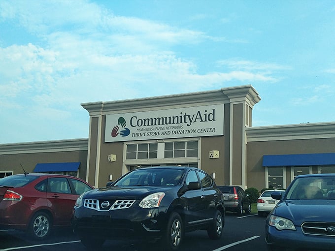 The promise of treasure hunting begins right at the entrance, where CommunityAid's colorful logo signals the start of your bargain adventure.