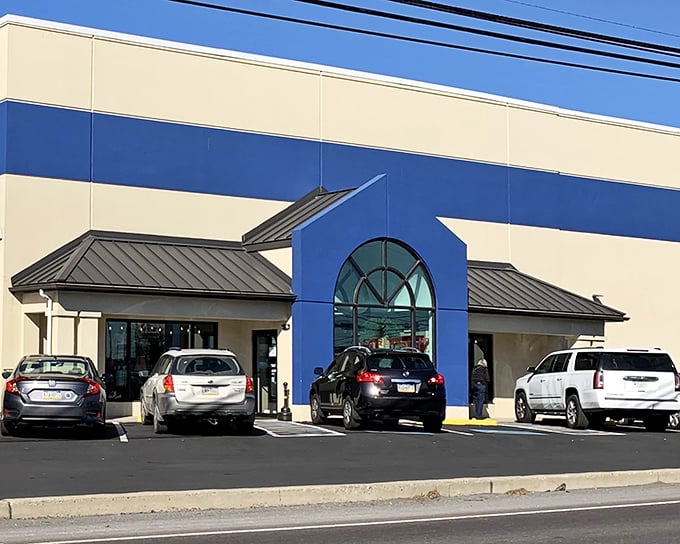 The blue and cream exterior of Re-Uzit Shop stands like a beacon of bargain possibilities, promising treasures within its welcoming doors.