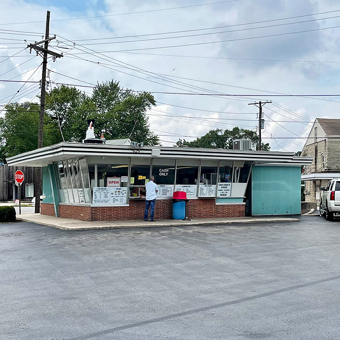 That iconic chicken sign stands proudly like a feathered beacon, promising crispy treasures within this turquoise temple.