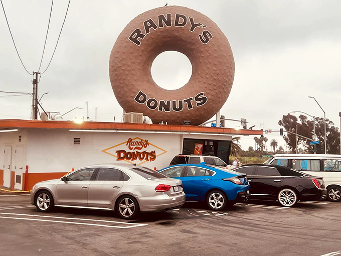 The most famous donut in America stands sentinel over Inglewood, a 32-foot testament to our collective sweet tooth and architectural whimsy.