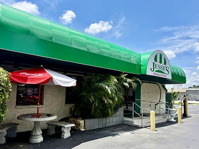 The iconic green awning of Jesse's Steak and Seafood stands like a beacon for hungry travelers. Florida's hidden steakhouse gem awaits behind those doors.