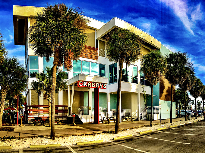 Modern coastal architecture meets Florida sunshine at Crabby's Dockside. The palm trees aren't just for show—they're nature's way of saying "vacation starts here."