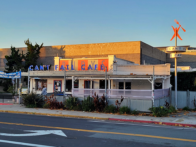 The neon-lit exterior of Rudy's Can't Fail Cafe stands as a beacon of comfort food in Emeryville, promising punk rock vibes and plates that satisfy.