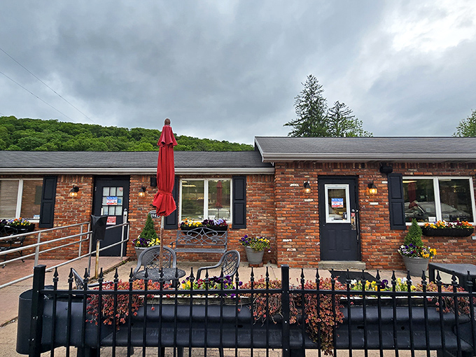 The unassuming brick exterior of The Pie Shoppe, where those cheerful red umbrellas beckon like beacons of sugary salvation in the Laurel Highlands.