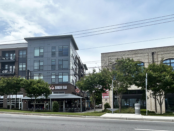 Bad Daddy's modern brick exterior beckons burger lovers with its inviting patio seating and string lights—urban comfort food paradise in Chamblee's evolving landscape.