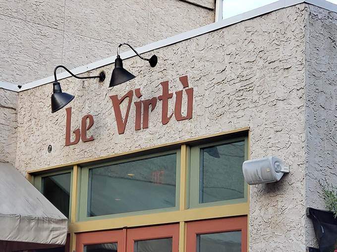 The understated exterior of Le Virtù belies the culinary treasures within. Those rustic stone walls and simple signage whisper rather than shout about the authentic Abruzzese experience awaiting you.