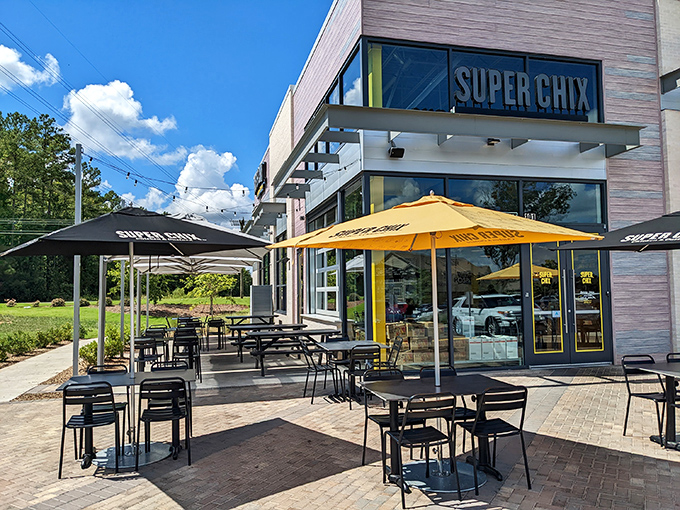 Super Chix's modern exterior with those cheerful yellow umbrellas isn't just inviting—it's practically waving you in for a chicken revelation.