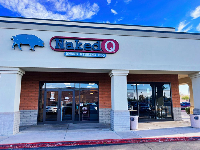 The blue pig silhouette beckons like a smoky siren call. NakedQ's unassuming strip mall exterior hides barbecue treasures that would make Texas weep with joy.