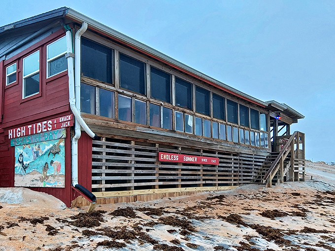 The iconic red exterior of High Tides at Snack Jack stands as a beacon of hope for hungry beachgoers, promising seafood salvation just steps from the Atlantic.