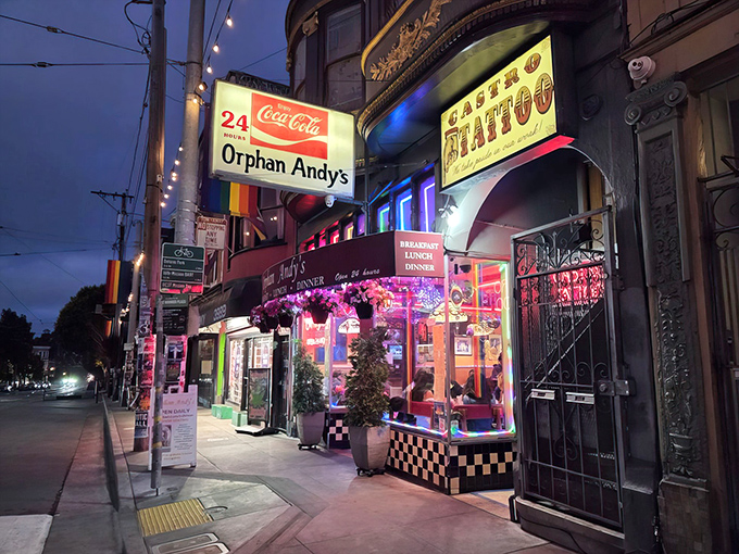 The iconic rainbow-striped entrance to Orphan Andy's beckons hungry visitors with its classic diner charm and vibrant Castro District energy.