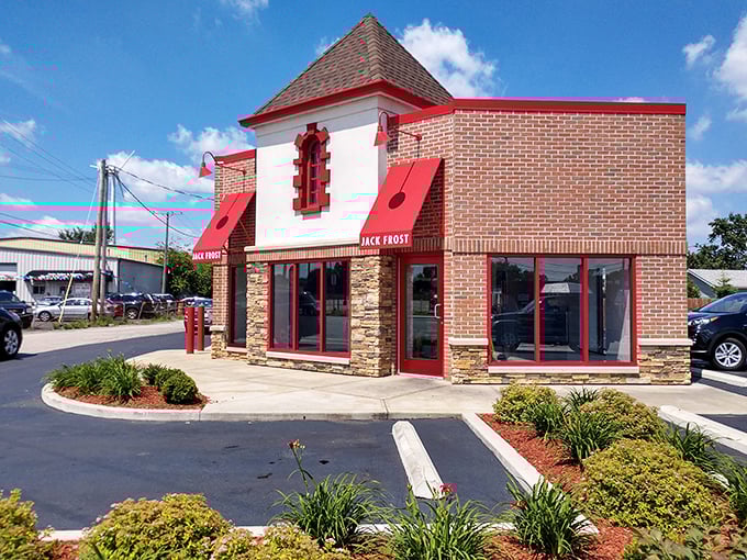 The white building with bold red signage stands like a beacon of sweetness on Pearl Road, promising "EVERY BATCH FRESH SCRATCH" – the donut lover's siren call.