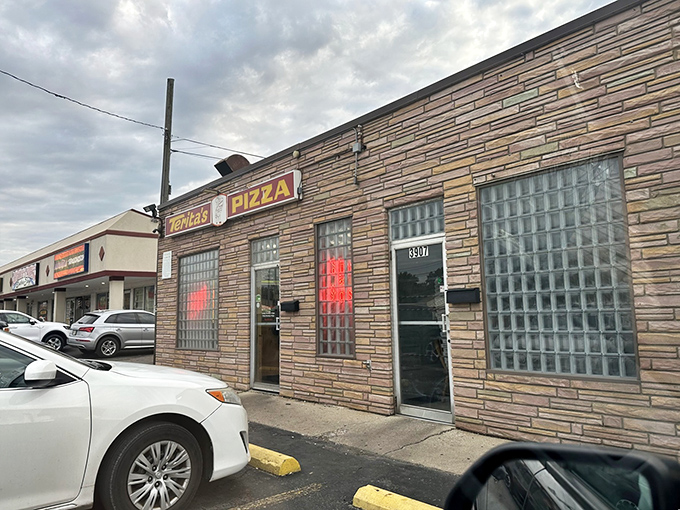 The unassuming brick exterior of Terita's Pizza proves once again that the best food often hides behind the most modest facades.