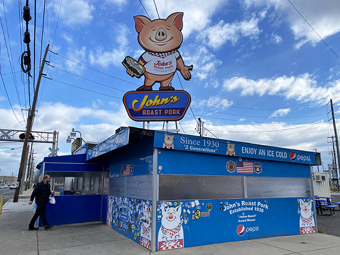 The iconic blue exterior with its cheerful cartoon pig mascot stands as a beacon of sandwich excellence in South Philly. No fancy frills needed.