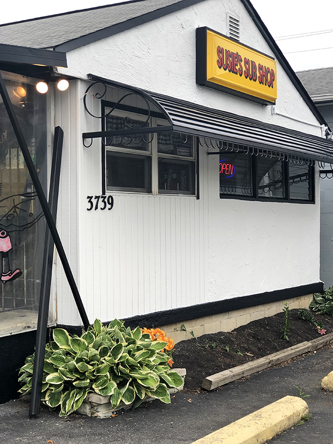 The unassuming white building with its bright yellow sign promises sandwich salvation to those in the know. No frills, just thrills.