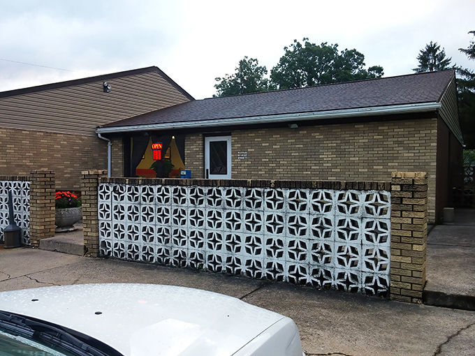 The unassuming exterior with its vintage decorative concrete wall is like finding a rare vinyl record in your uncle's attic—unremarkable until you discover what's inside.