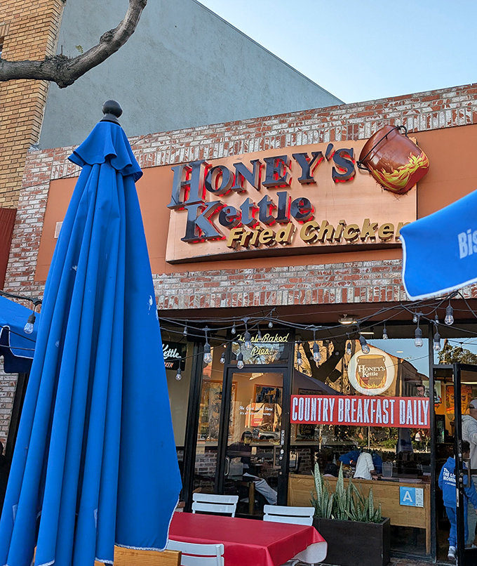 The orange-brick facade and string lights of Honey's Kettle beckon like a siren song for fried chicken aficionados.