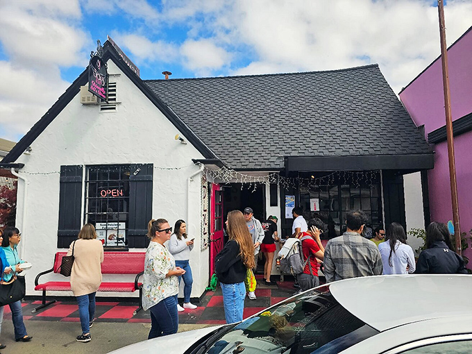 The pink door and checkered patio aren't just cute design choices—they're beacons calling breakfast lovers home to Sax's Joint in Petaluma.