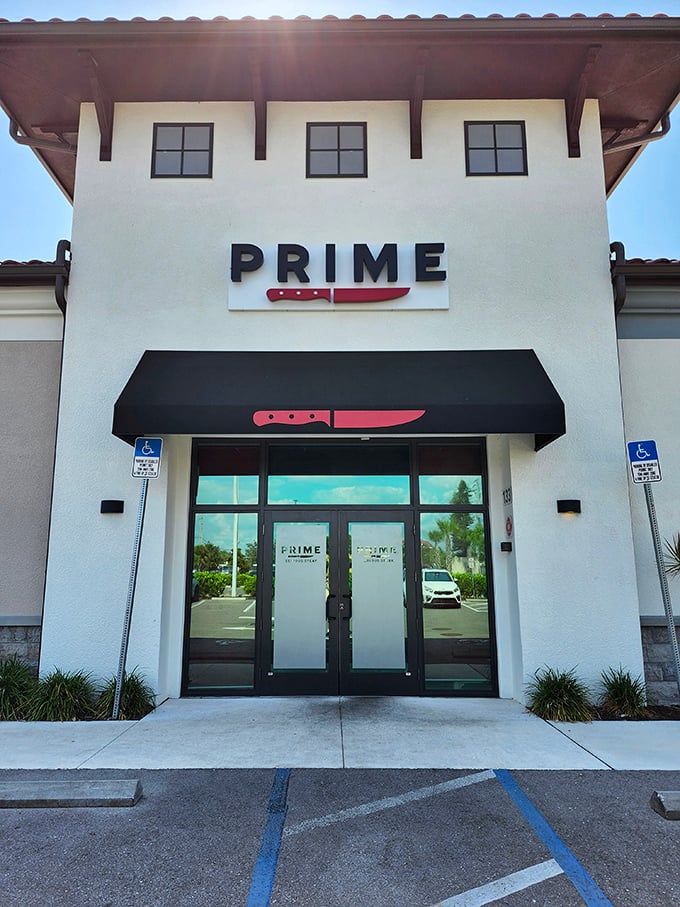 The striking white exterior with its bold red knife logo promises serious business when it comes to steak. This isn't a place that minces words—or meat.