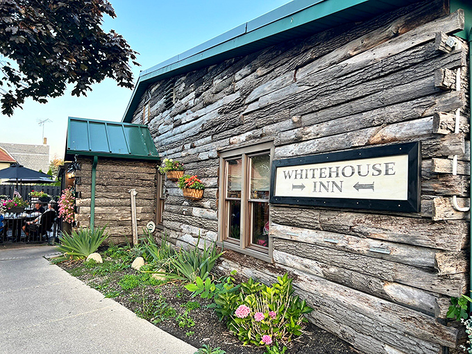 The log cabin exterior of The Whitehouse Inn isn't trying to be rustic chic – it's the real deal, complete with a patio that beckons you to linger.