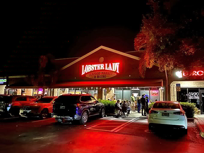The glowing red sign of Lobster Lady beckons seafood lovers like a lighthouse guiding hungry sailors to shore.