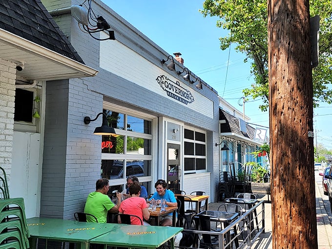 The white-brick façade of The Governor welcomes diners with charming outdoor seating. Hanging ferns and street-side tables create the perfect people-watching perch.