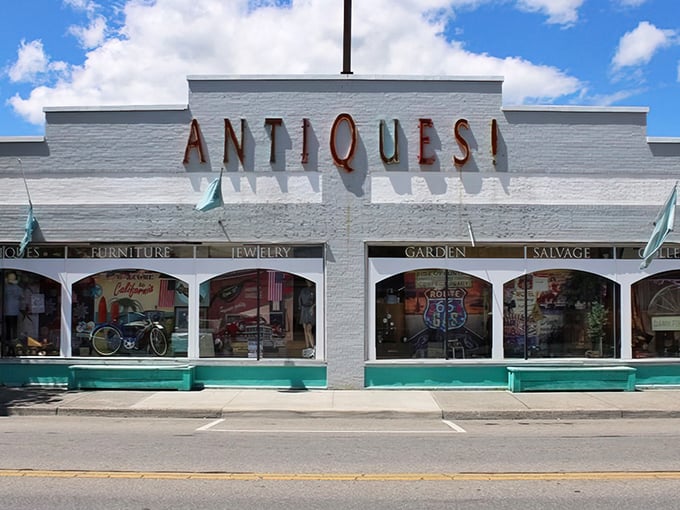 The white facade with its bold "ANTIQUES!" sign is like a siren call to treasure hunters. This isn't just shopping—it's time travel with a parking lot.