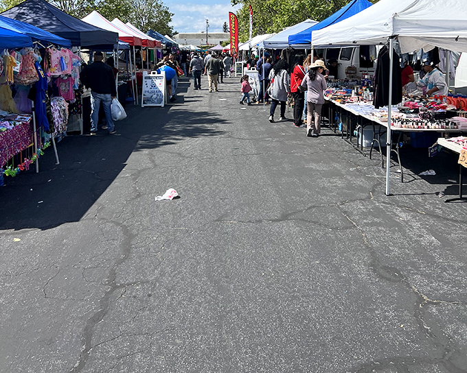 Rows of white tents create a treasure hunter's paradise at Laney College Flea Market. The real magic happens when you venture down these pathways of possibility.