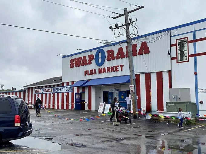The red, white, and blue facade of Swap-O-Rama stands like a patriotic monument to American bargain hunting—where treasures await behind those striped walls.