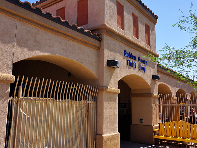 The unassuming exterior of Golden Goose Thrift Shop stands like a treasure chest in the desert, promising bargain-hunting adventures behind its Spanish-style façade.
