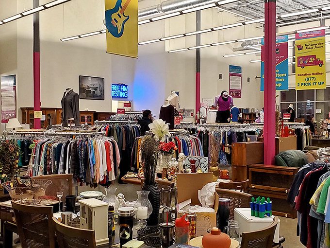 The sprawling interior of Out of the Closet feels more like a well-organized department store than a typical thrift shop, with colorful banners adding a festive touch to the high ceilings.