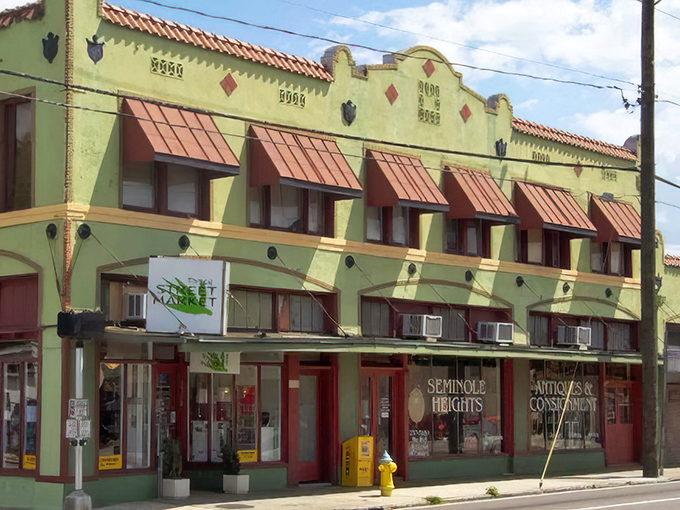 The historic Spanish-influenced façade of Retro Mania Vintage Market stands as a time capsule on Tampa's streets, copper awnings telling stories of decades past.
