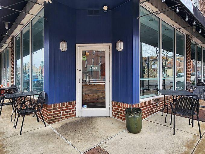 The blue storefront with its "HAND CARVED SANDWICHES" awning is like Clark Kent's glasses – a humble disguise for sandwich superhero powers within.