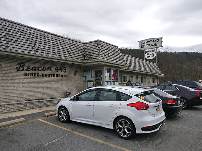 The weathered sign of Beacon 443 stands like a sentinel along the highway, promising "Family Dining" with no pretense—just honest food and warm welcomes.