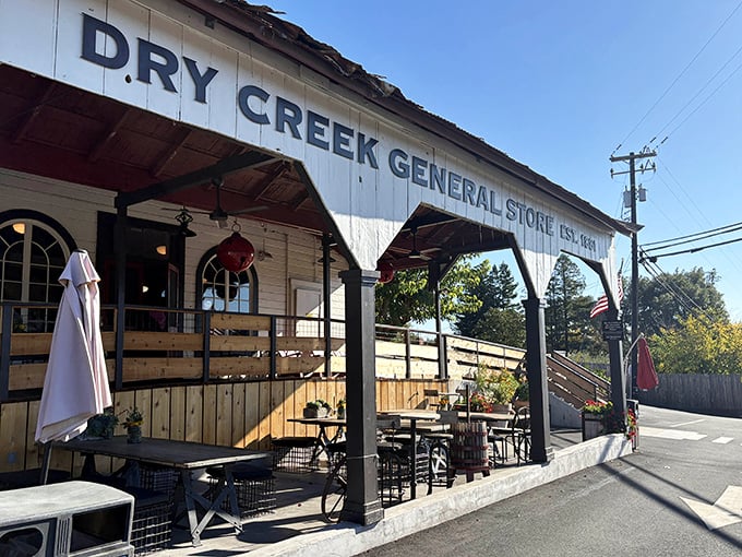 The white clapboard exterior of Dry Creek General Store stands like a time capsule in wine country, complete with "THE BAR" proudly displayed for weary travelers.