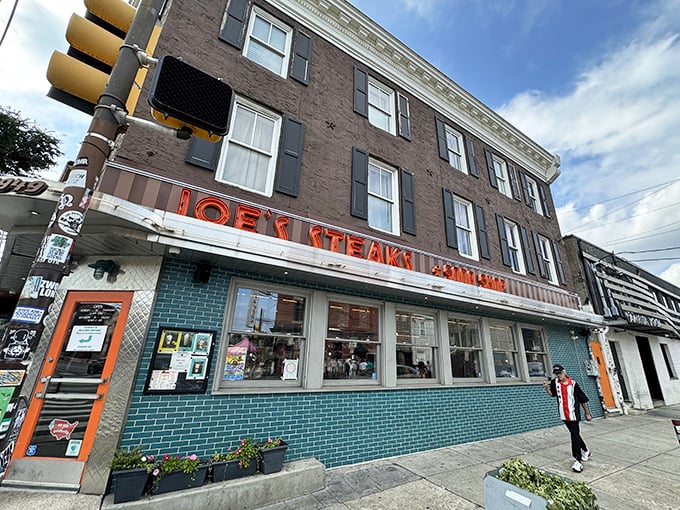 That iconic neon sign glowing against Fishtown's brick backdrop isn't just advertising – it's a beacon of hope for the cheesesteak-deprived soul.